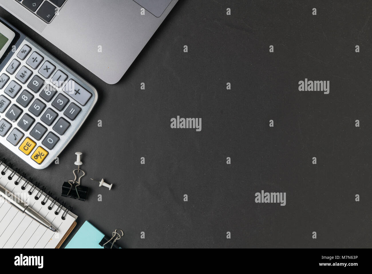 Office black stone desk table with calculator, laptop and pen, business ...