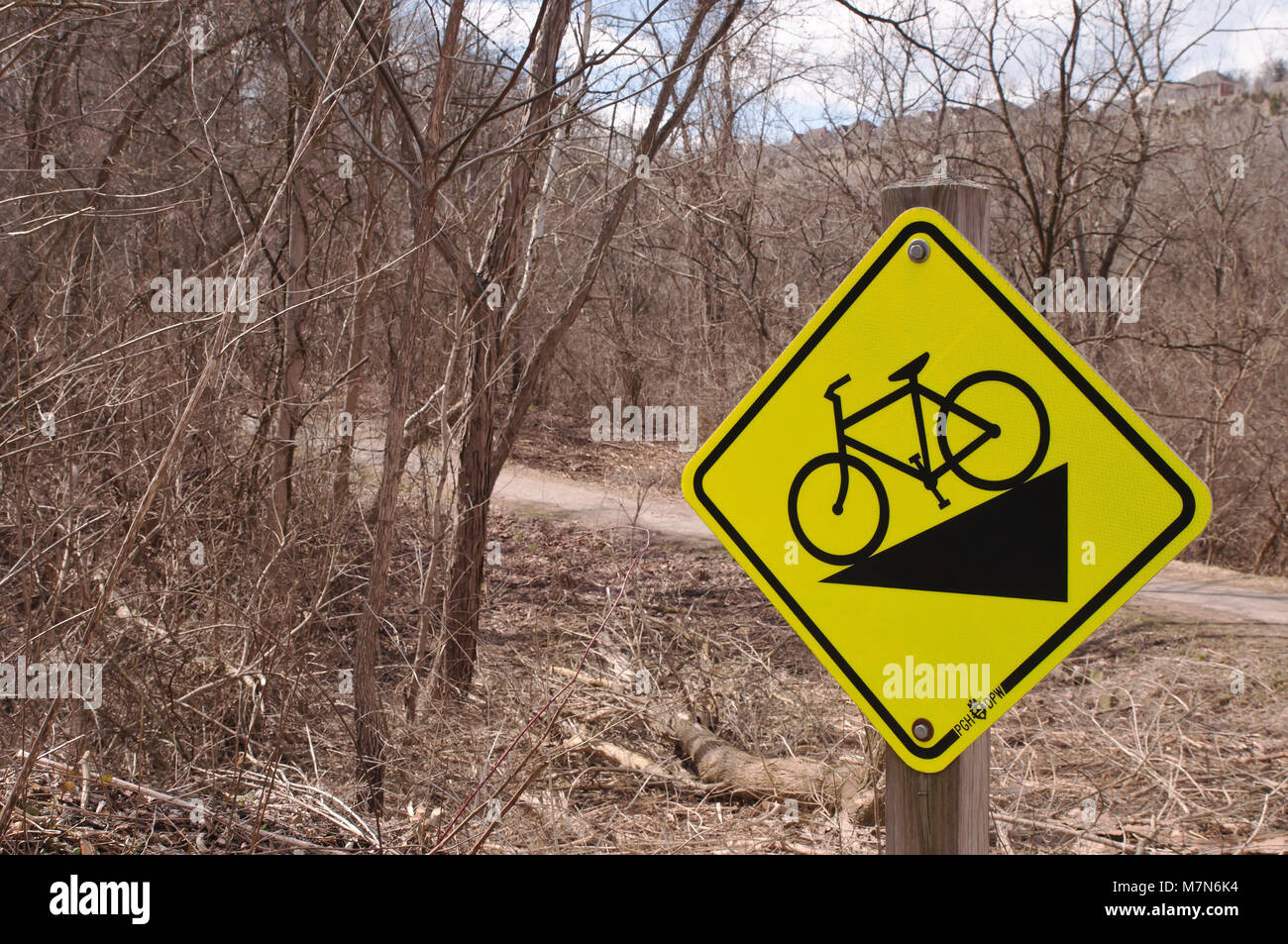 A downhill biking sign in the woods next to a path Stock Photo - Alamy