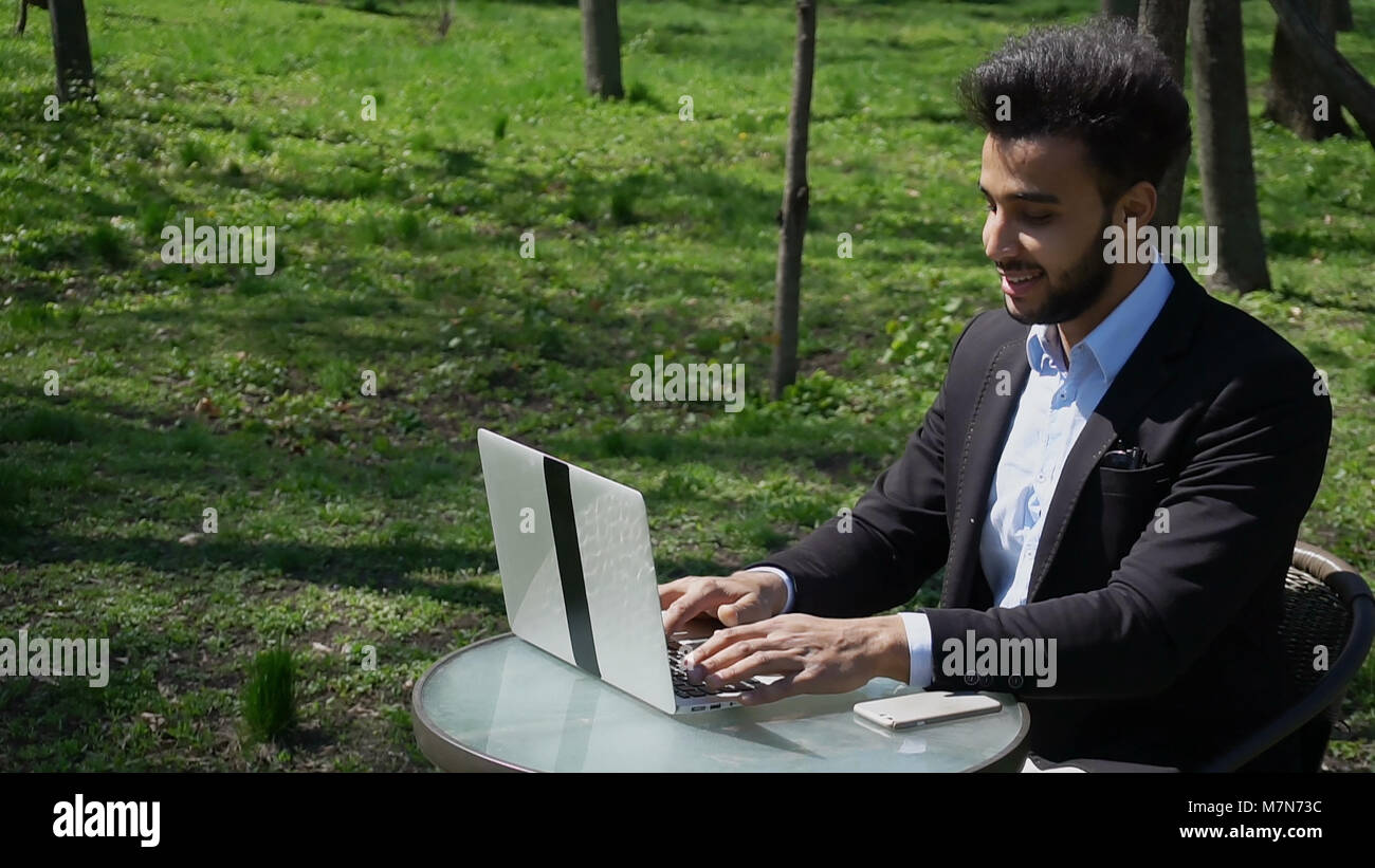Journalist finished work in park Stock Photo - Alamy