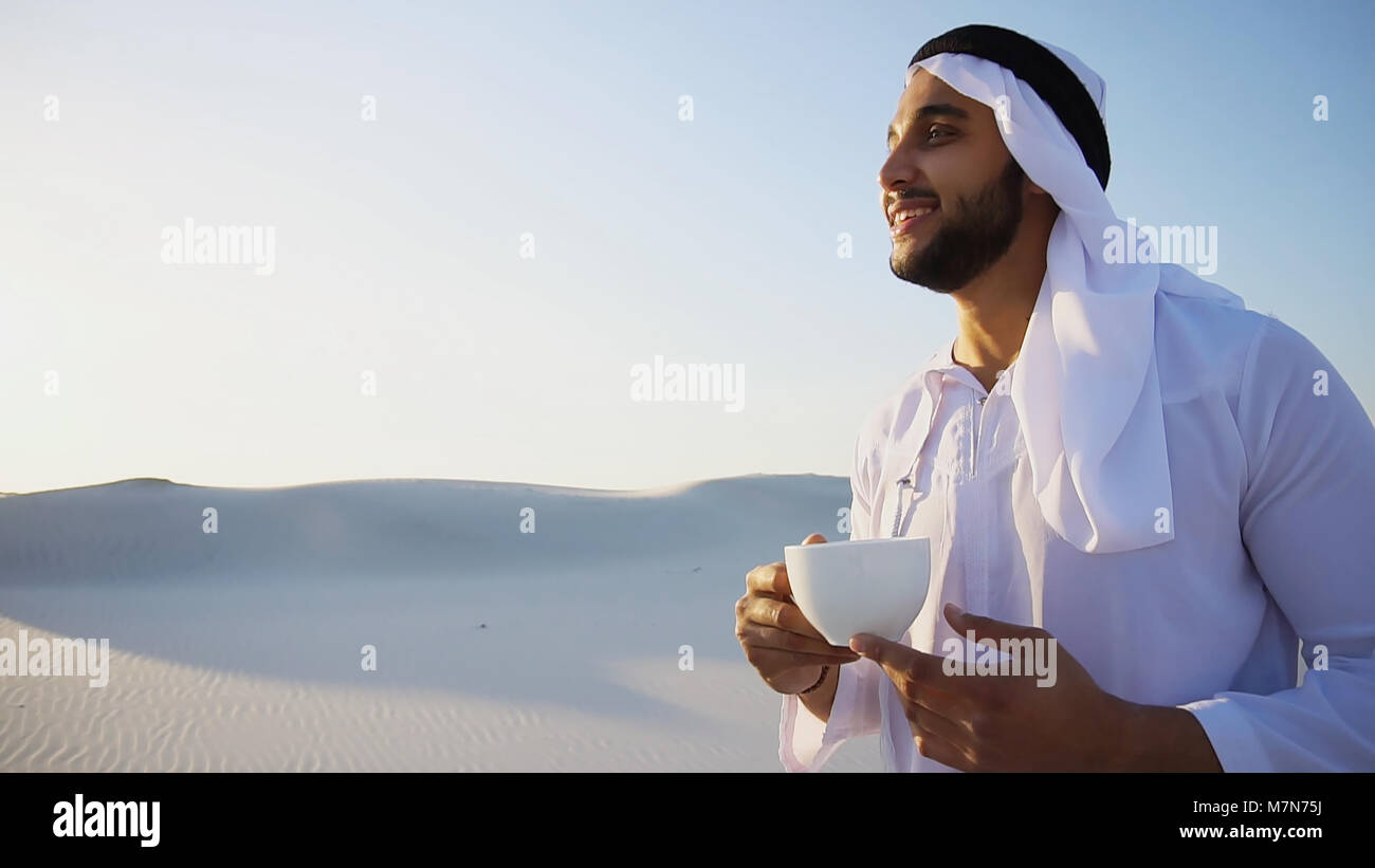 Portrait of handsome young Arabian Sheikh who drinks from cup of Stock ...