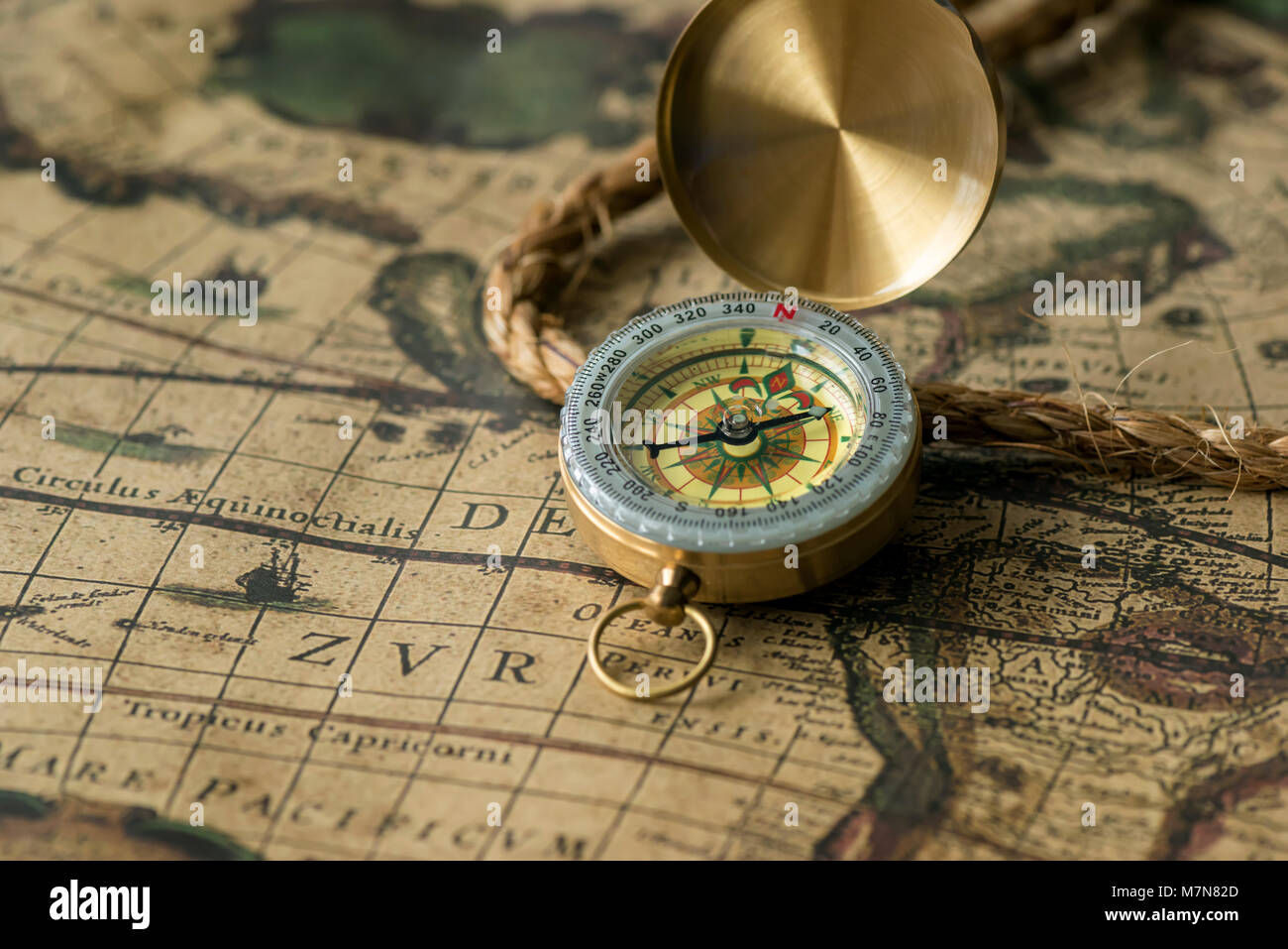 Old compass on vintage map with rope closeup. Retro stale Stock Photo ...