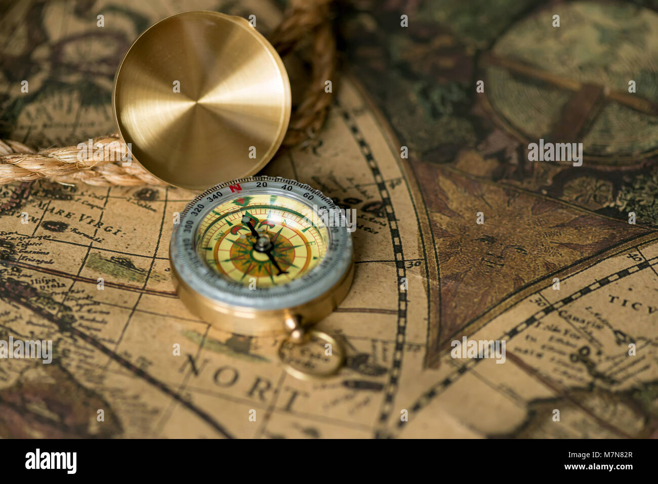 Old compass on vintage map with rope closeup. Retro stale Stock Photo ...