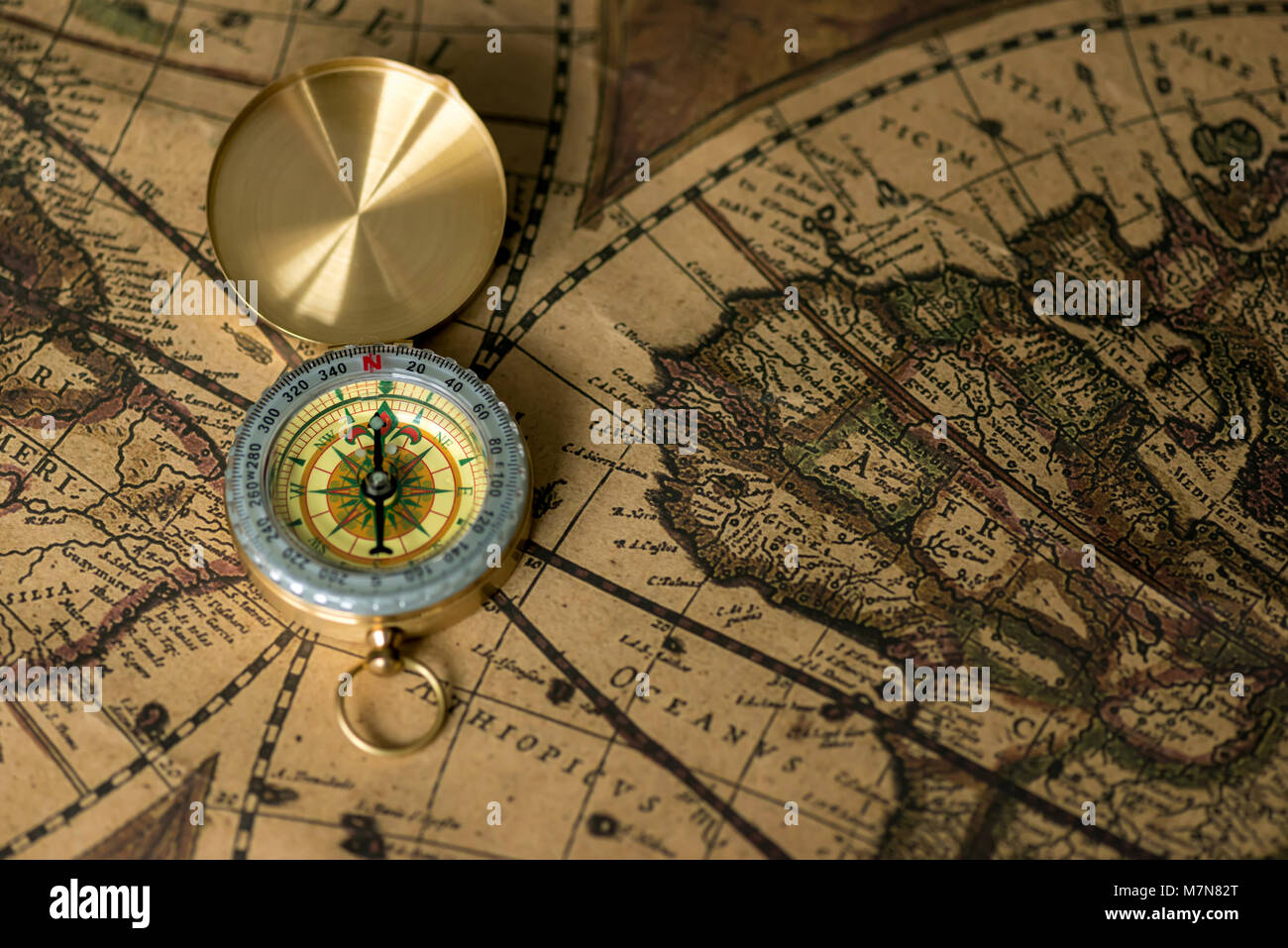 Old compass on vintage map. Retro stale Stock Photo - Alamy