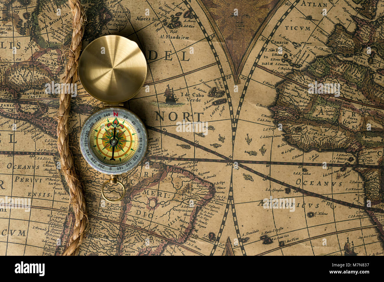 Old compass on vintage map with rope closeup. Retro stale Stock Photo ...