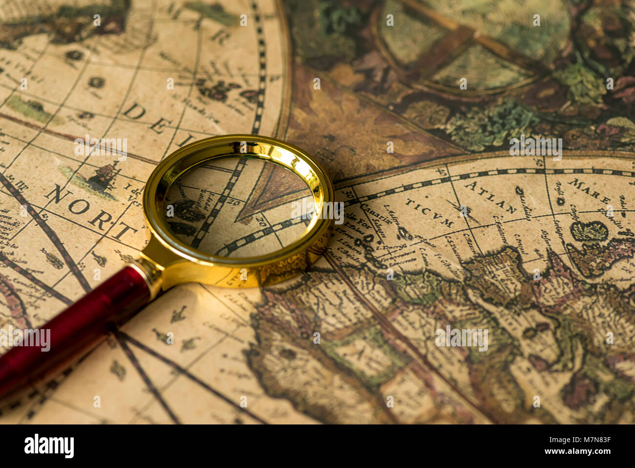 Retro magnifier with old map closeup Stock Photo - Alamy