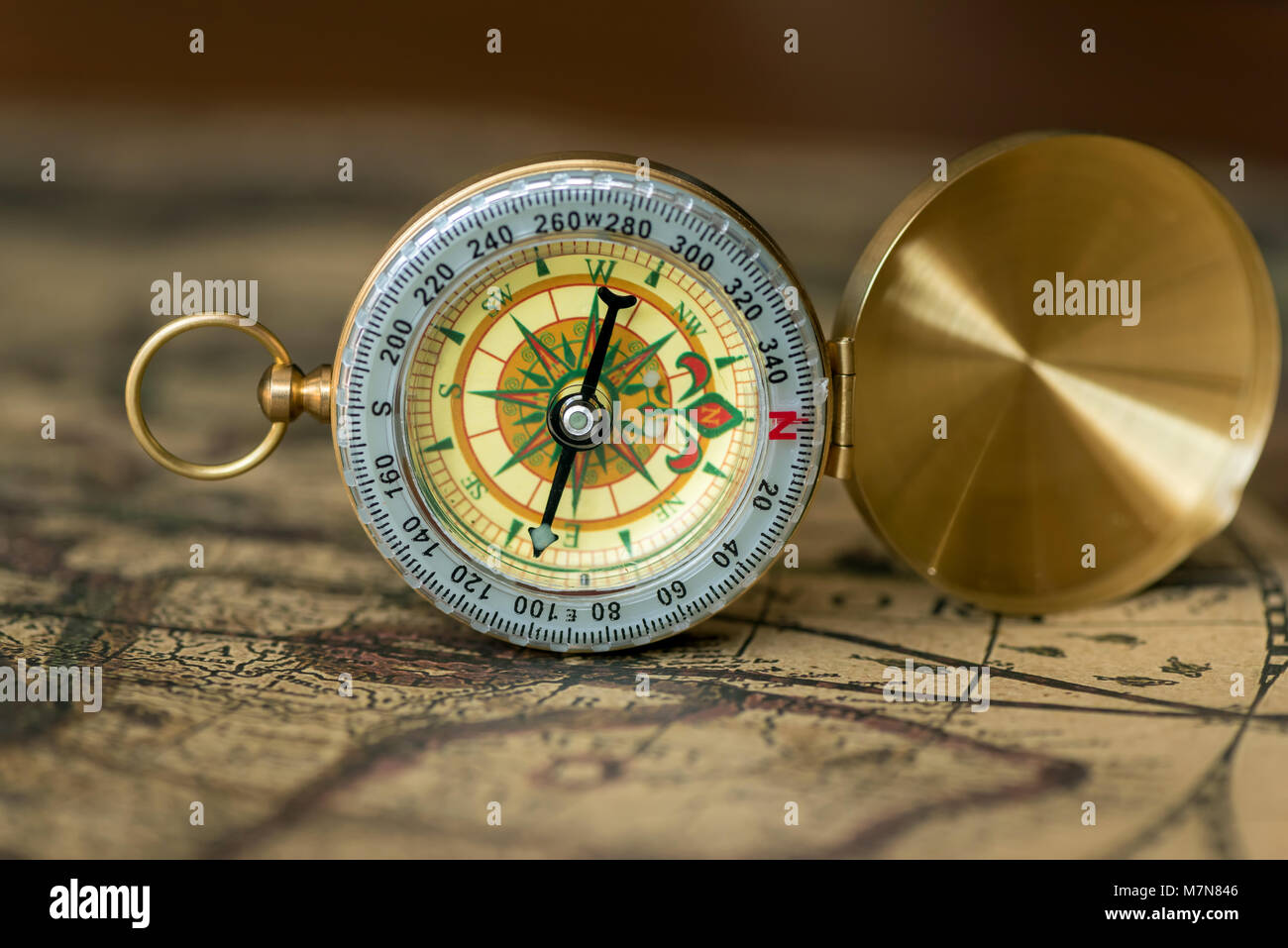 Old compass on vintage map. Retro stale Stock Photo - Alamy