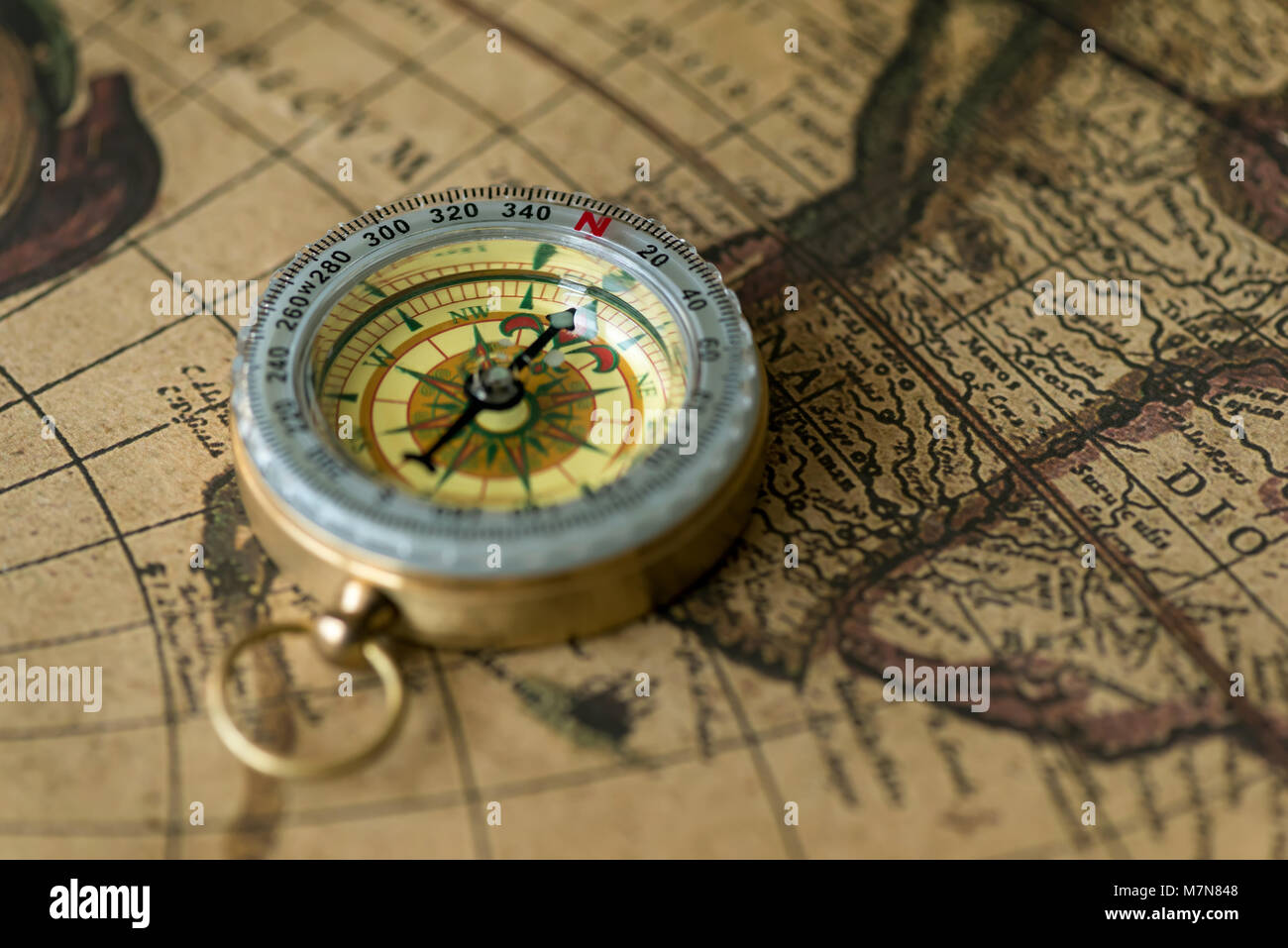 Old compass on vintage map. Retro stale Stock Photo - Alamy
