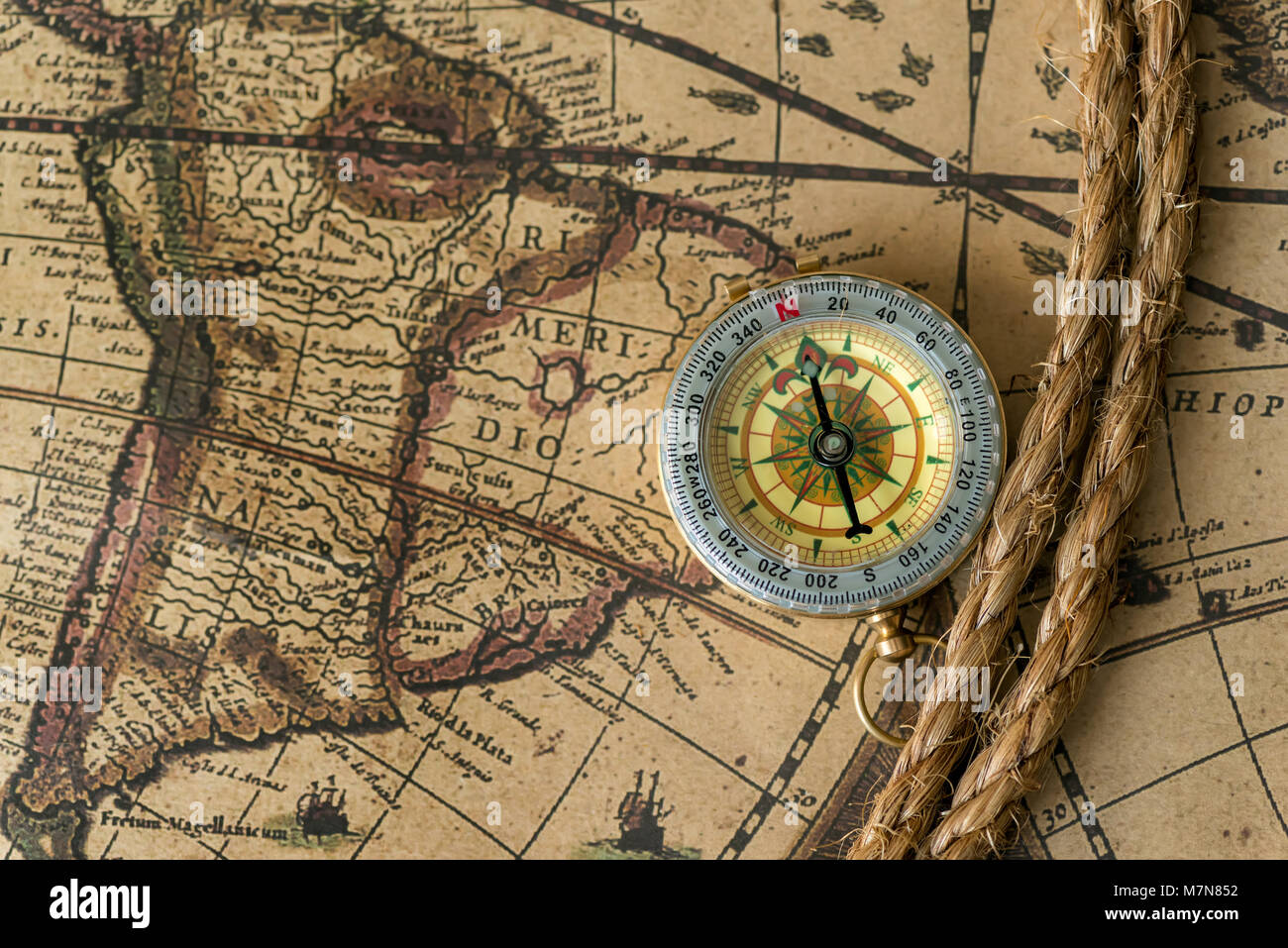 Old compass on vintage map with rope closeup. Retro stale Stock Photo ...
