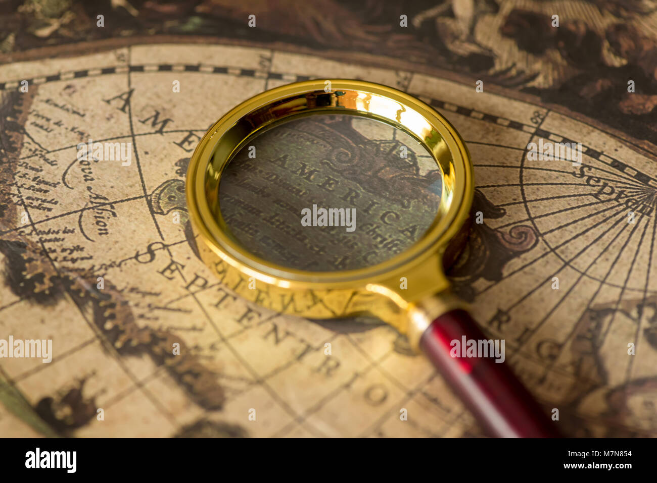 Retro magnifier with old map closeup Stock Photo - Alamy