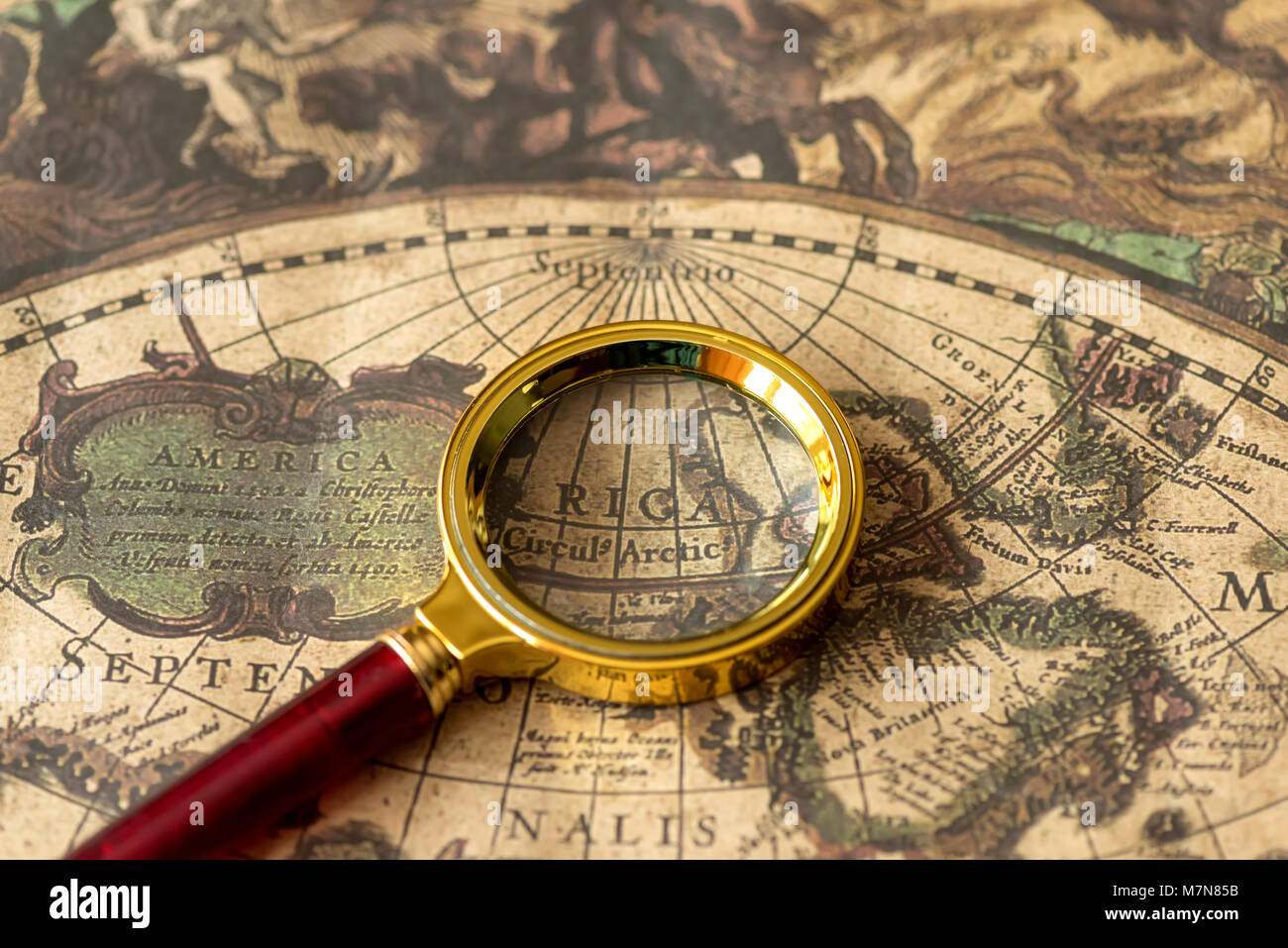 Retro magnifier with old map closeup Stock Photo - Alamy
