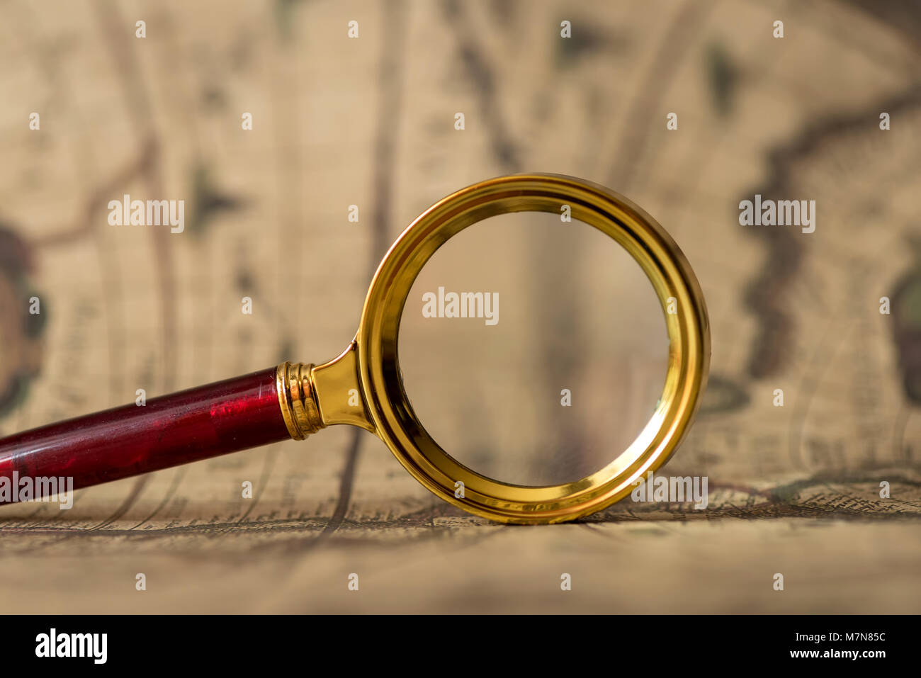Retro magnifier with old map closeup Stock Photo - Alamy