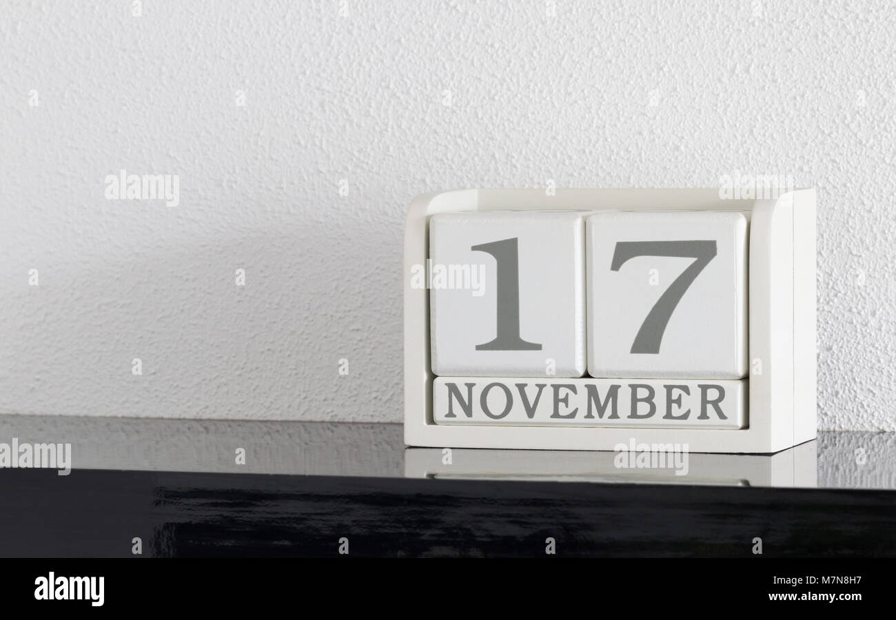 White block calendar present date 17 and month November on white wall ...