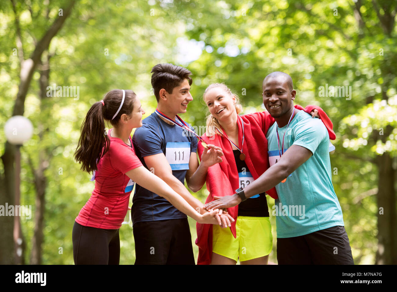 Group of young fit friends happy after finishing race Stock Photo - Alamy