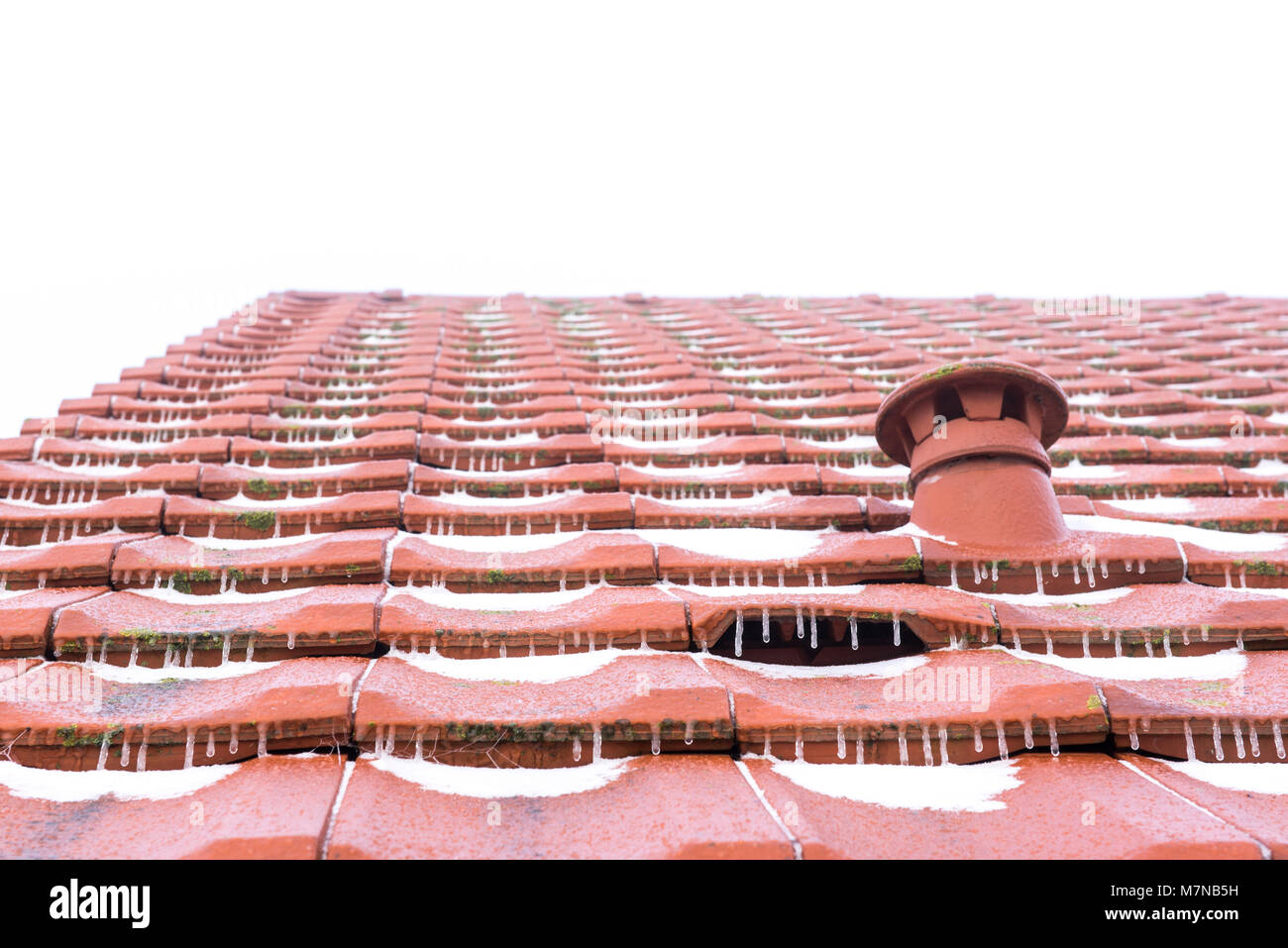 Red roof tile coveren by ice and snow Stock Photo - Alamy