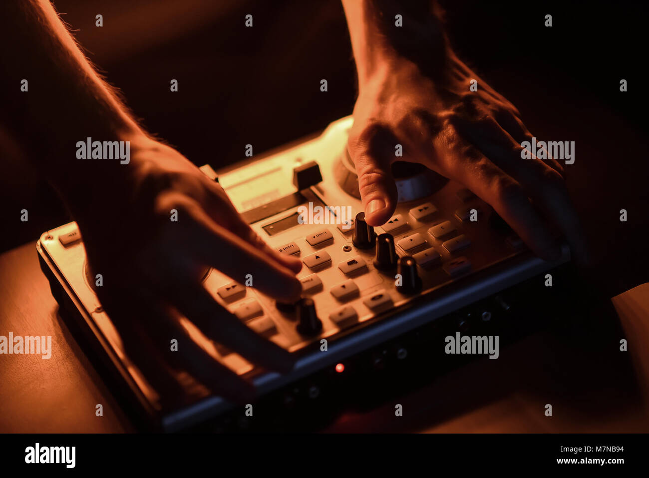 DJ mixer disco illuminated by searchlights Stock Photo - Alamy