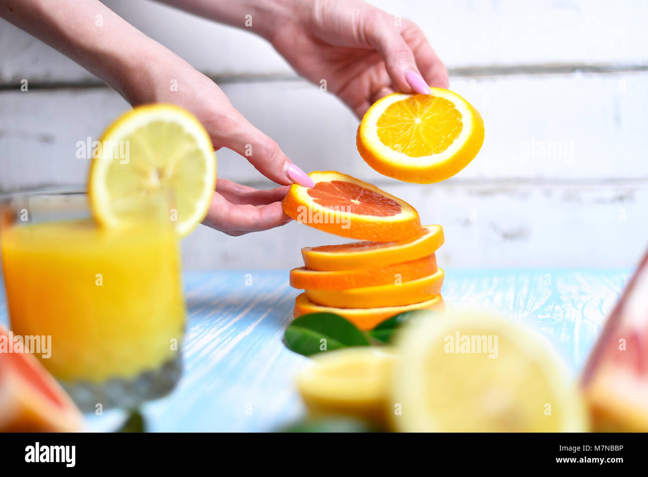 The orange in the hands Stock Photo - Alamy