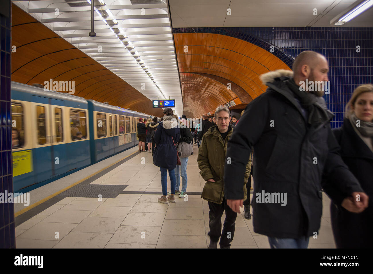 Passengers leave the train platform after disembarking from a subway ...