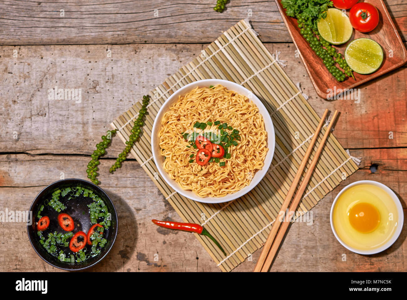 instant noodles in bowl with vegetable on wooden table Stock Photo - Alamy