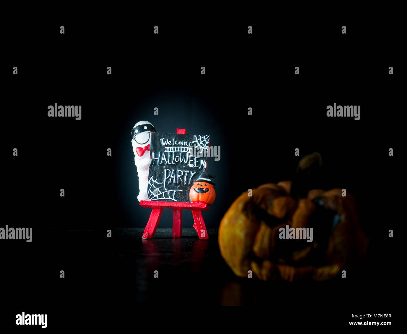 Welcome halloween party notice board on black background, blurred image ...