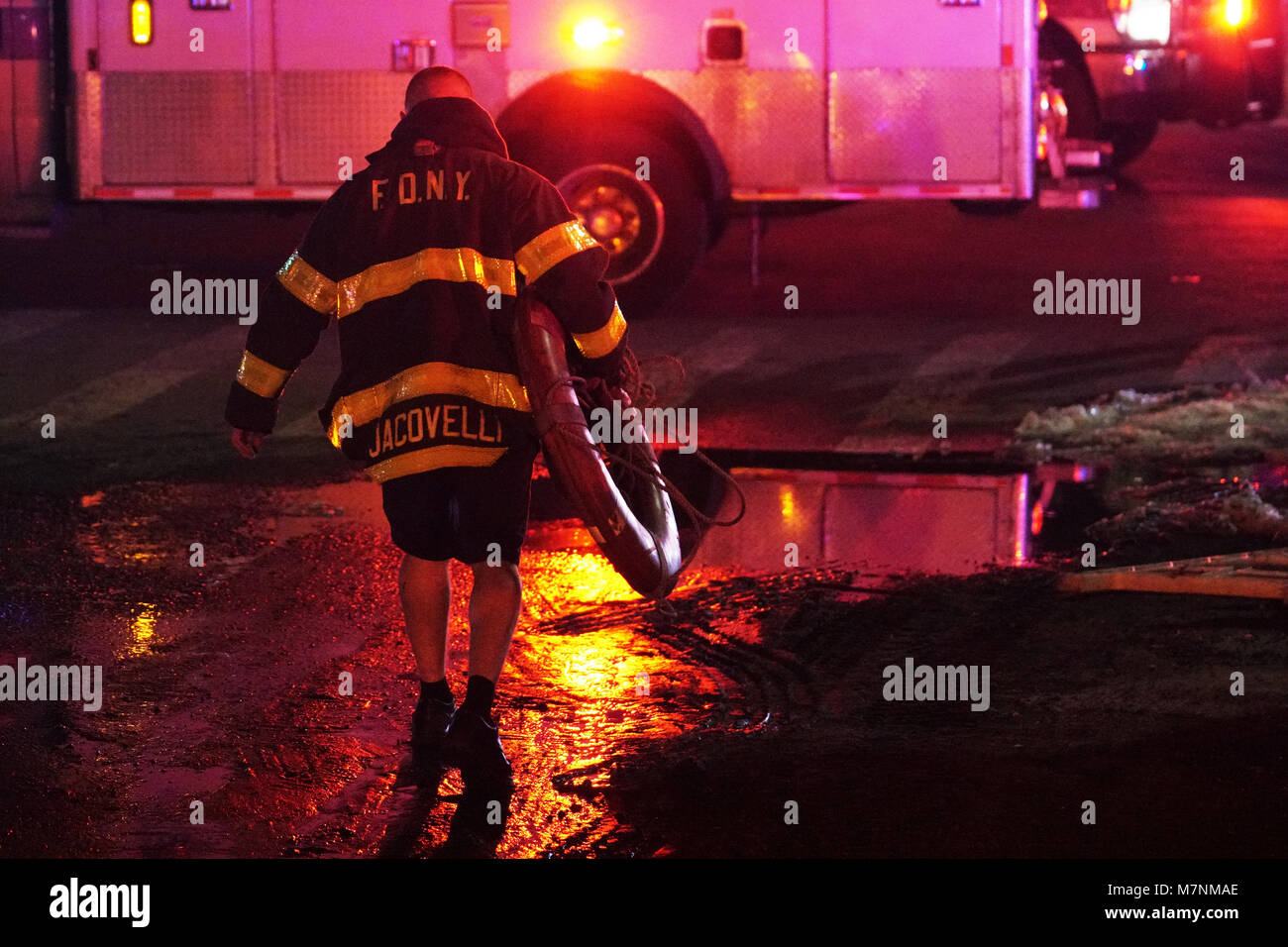 Manhattan, NY, USA. 11th Mar, 2018. FDNY rescue personnel carries a ...
