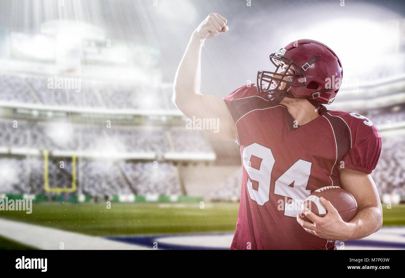 american football player celebrating touchdown on big modern stadium ...