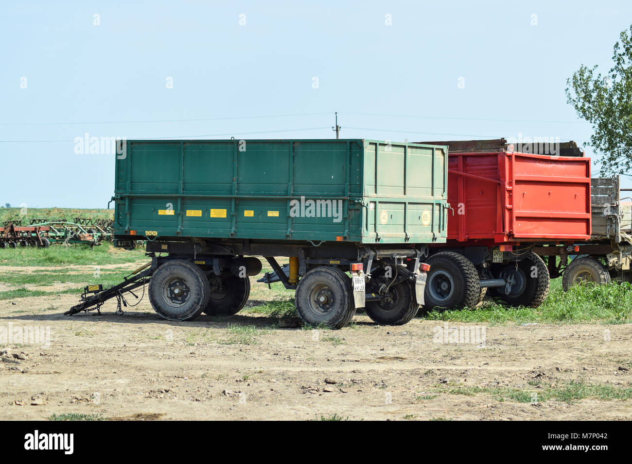 Russia, Temryuk - 15 July 2015: Trailers trucks for a tractor. The ...