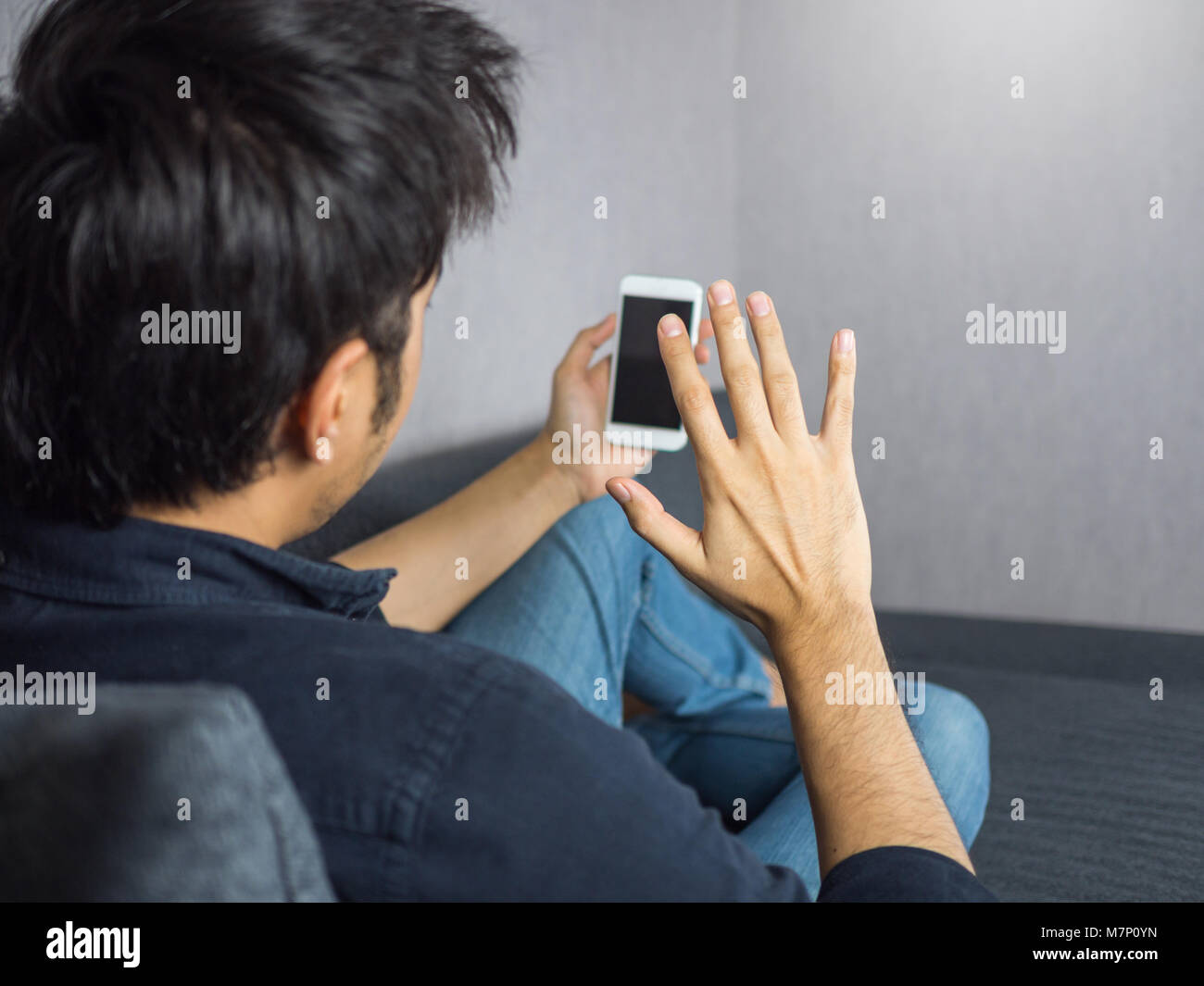 Man holding phone, waving at the phone, making video call Stock Photo ...