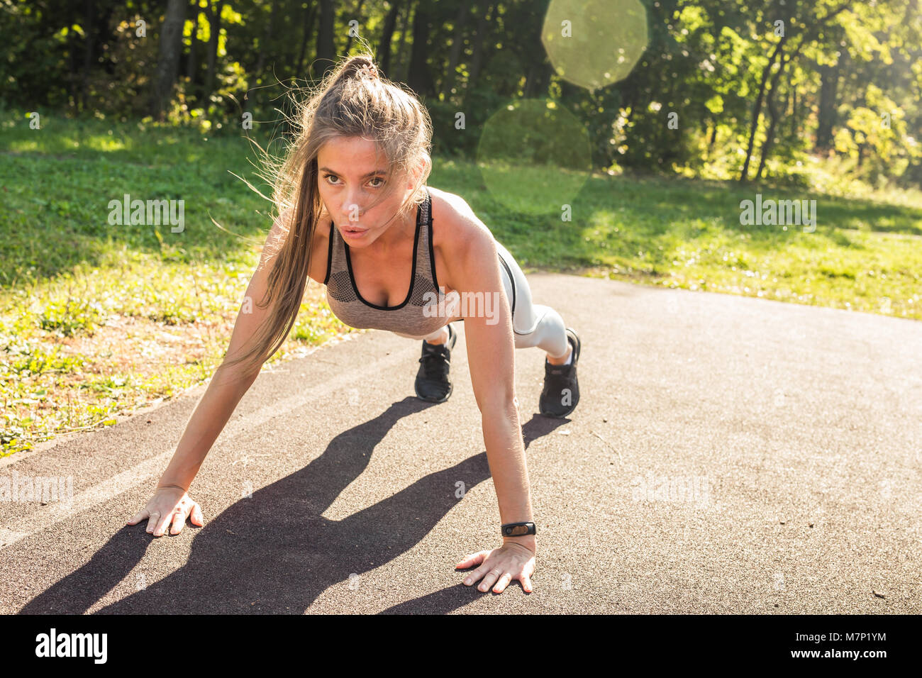 Fit woman doing push-ups at the park Stock Photo - Alamy
