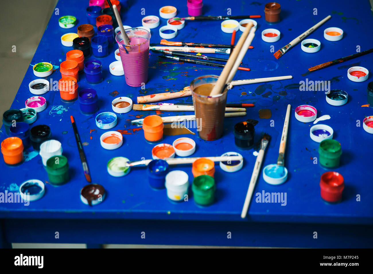 creative mess on the artist's desk at a children's party, soft focus ...
