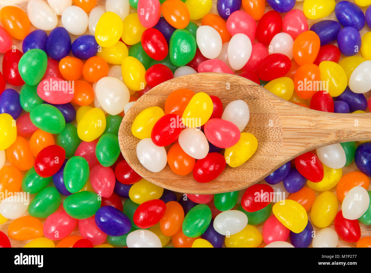 Many brightly colored jelly beans in a rainbow of colors. Popular candy ...