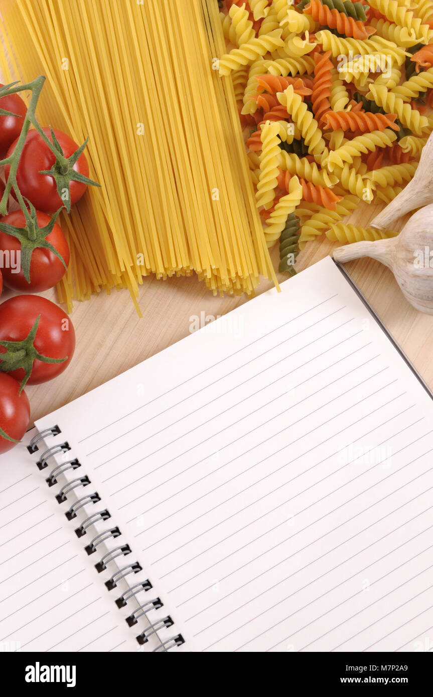 Selection of Italian spaghetti and pasta with blank recipe book or ...