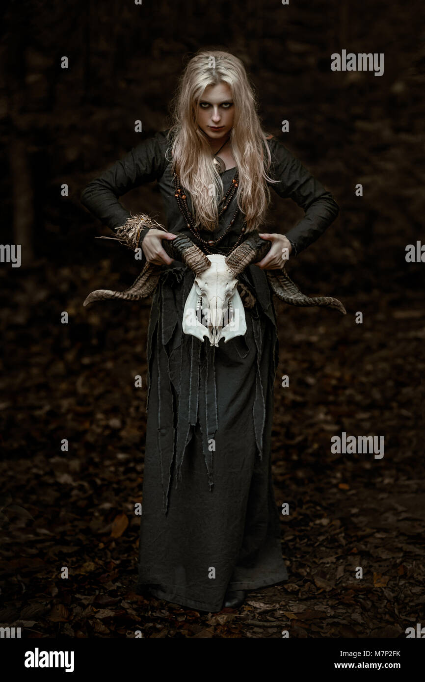 Witch in a long black dress Stock Photo - Alamy