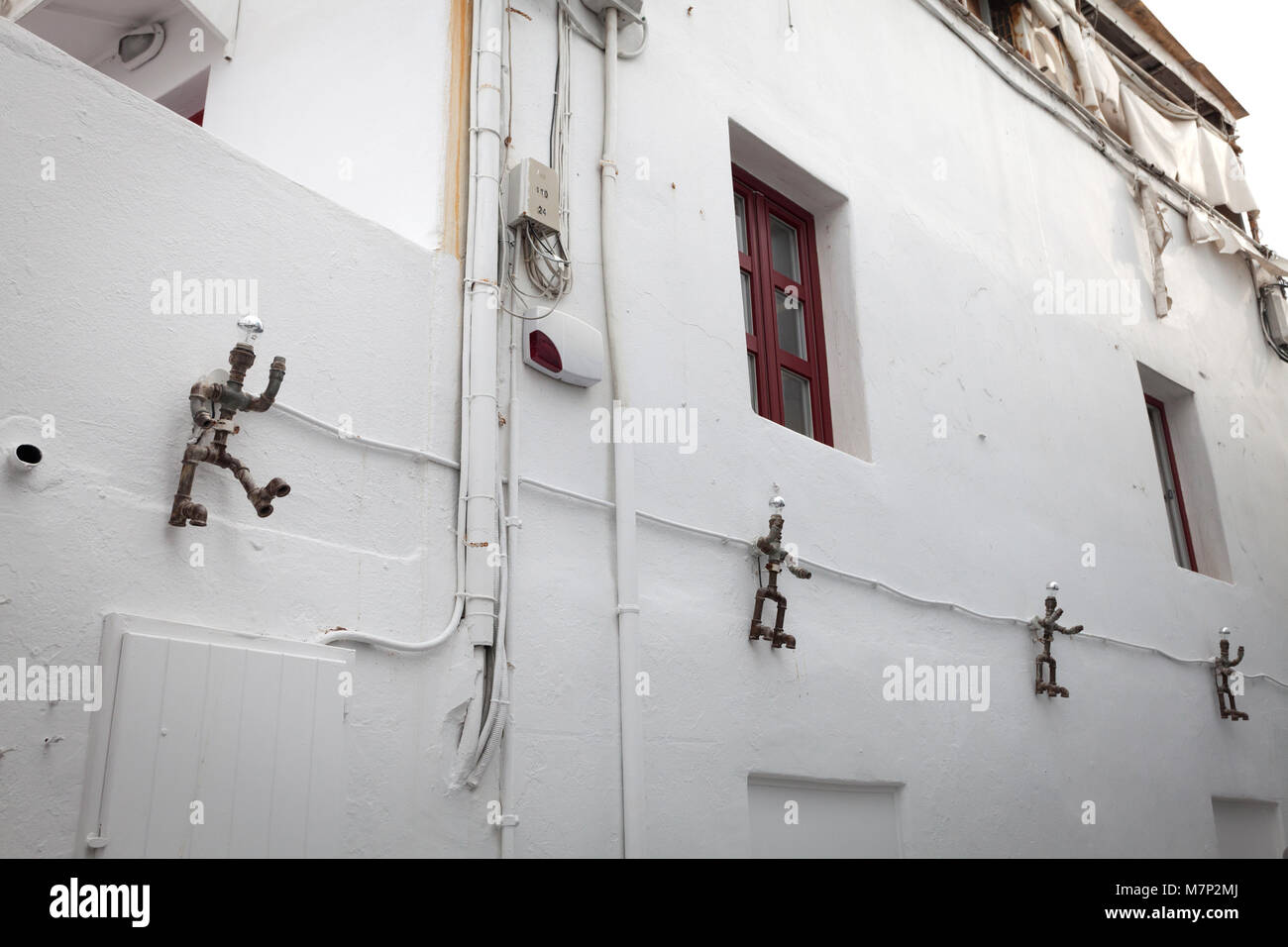 Funny gas pipes with a human robot shapes, acting as a street lights ...