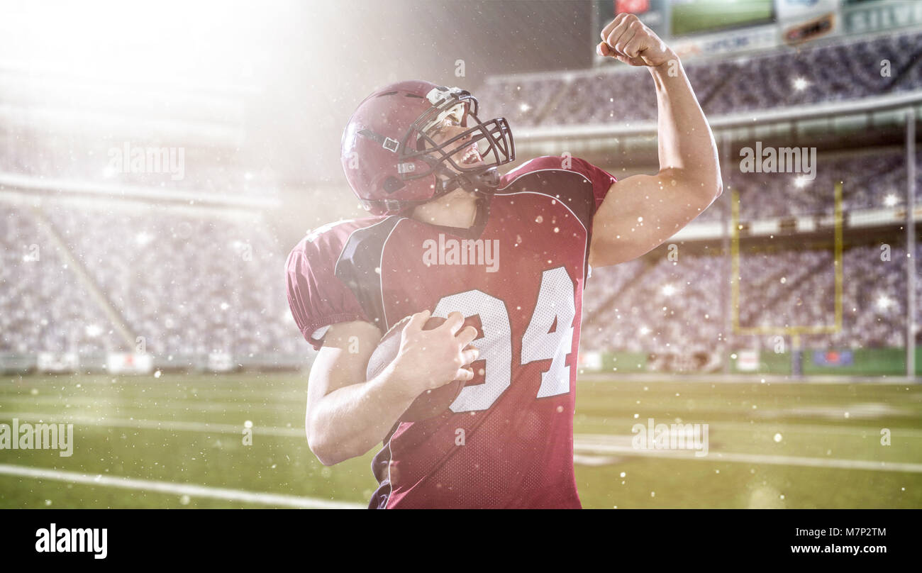 american football player celebrating touchdown on big modern stadium ...