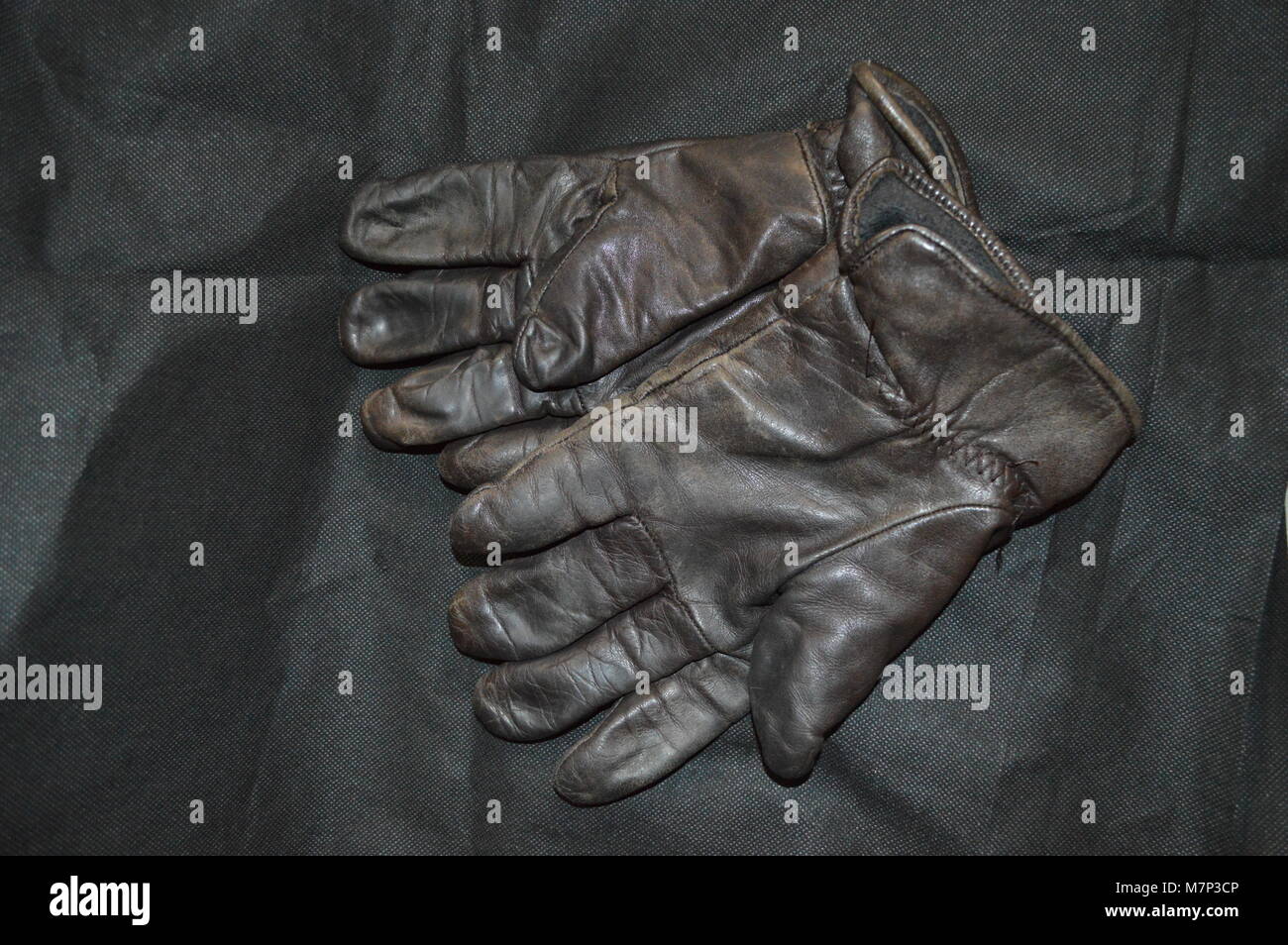 Old leather mans gloves on black background Stock Photo - Alamy
