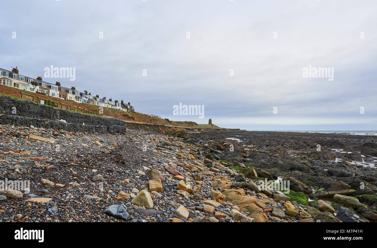 A line of old terraced Fishing Cottages look out over St Monans beach ...