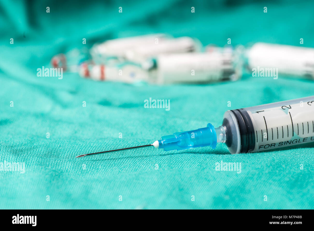 syringe and medical vials isolated on hospital green background Stock ...