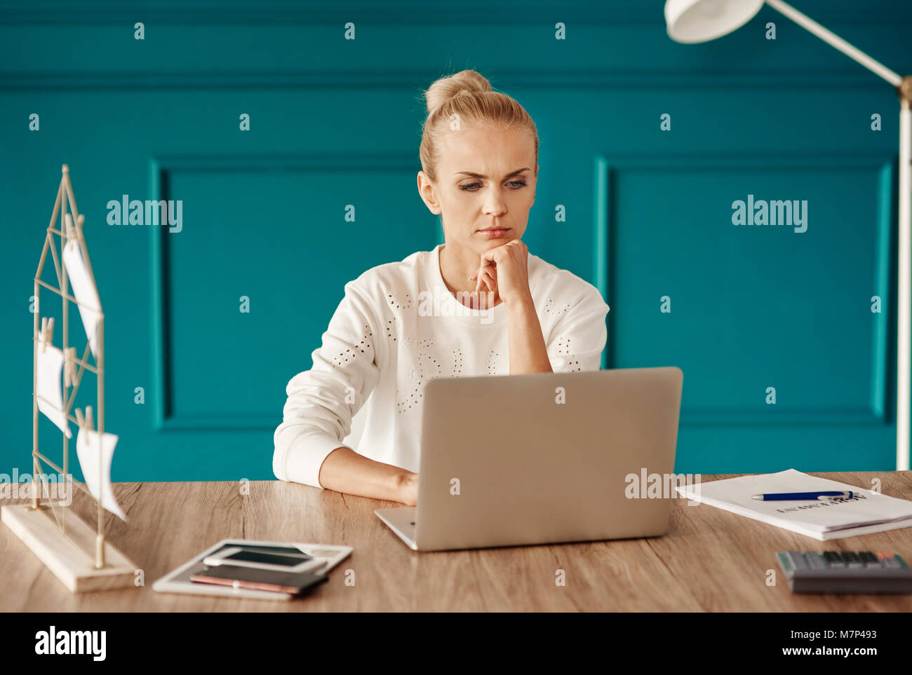 Focused and serious woman working with laptop Stock Photo - Alamy