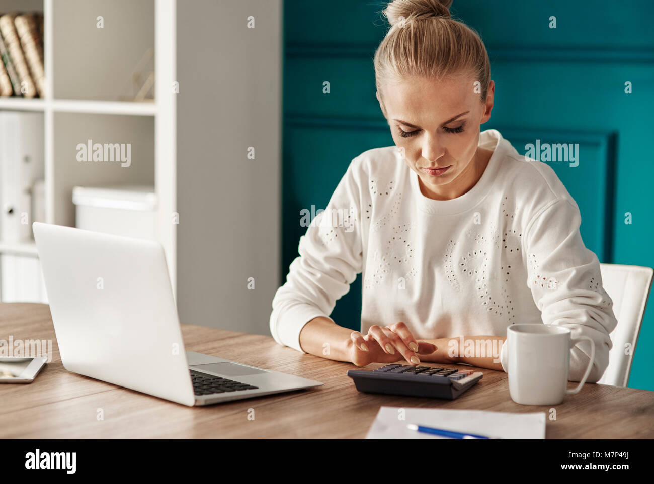 Serious woman planning her budget Stock Photo - Alamy
