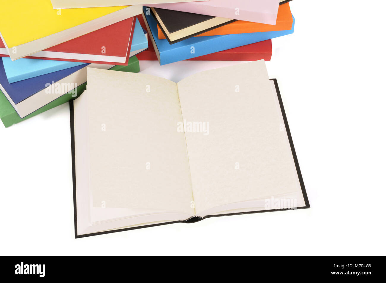 Blank book laying amongst a collection of colorful books isolated on a ...