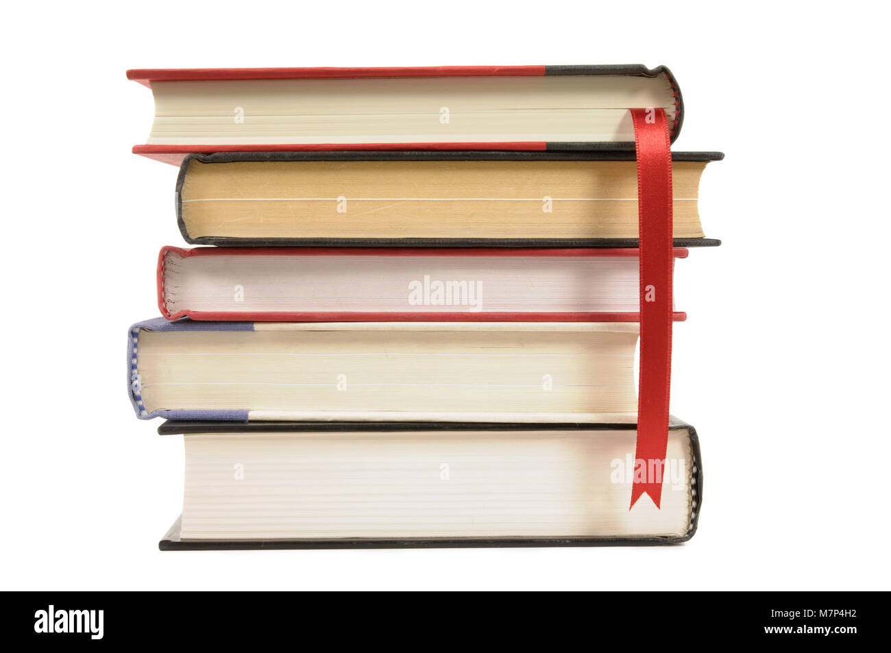 Small stack of hardback books with bookmark ribbon isolated against a ...