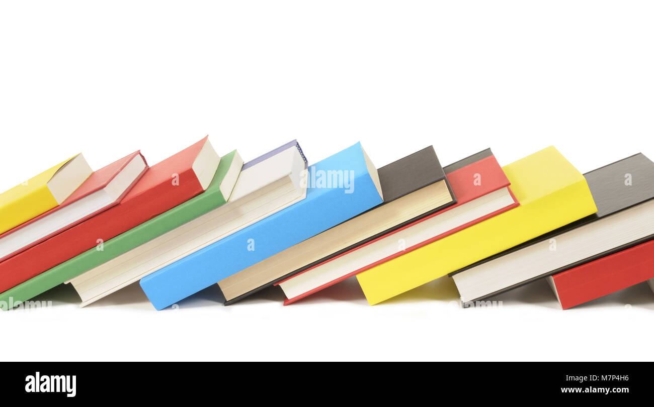 Leaning row of colorful books isolated against a white background ...