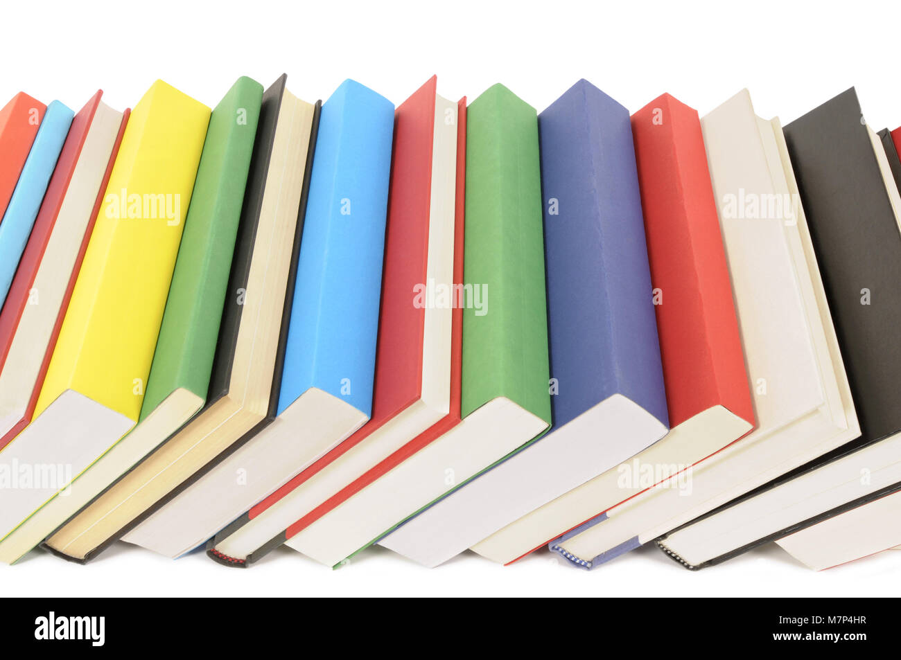Leaning row of colorful books isolated against a white background Stock ...