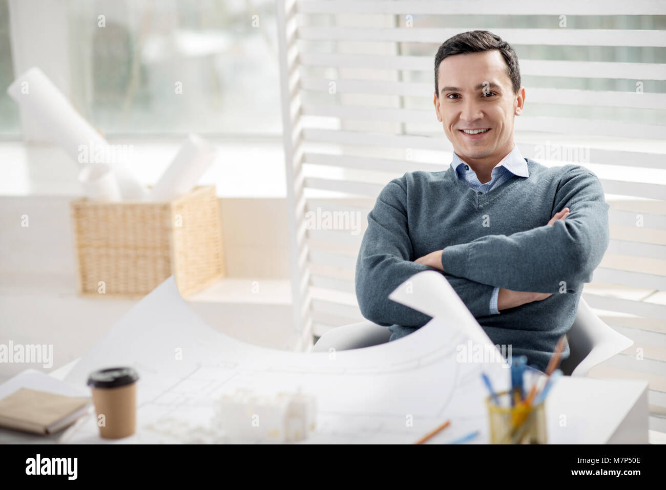 Happy young man working in his office Stock Photo - Alamy