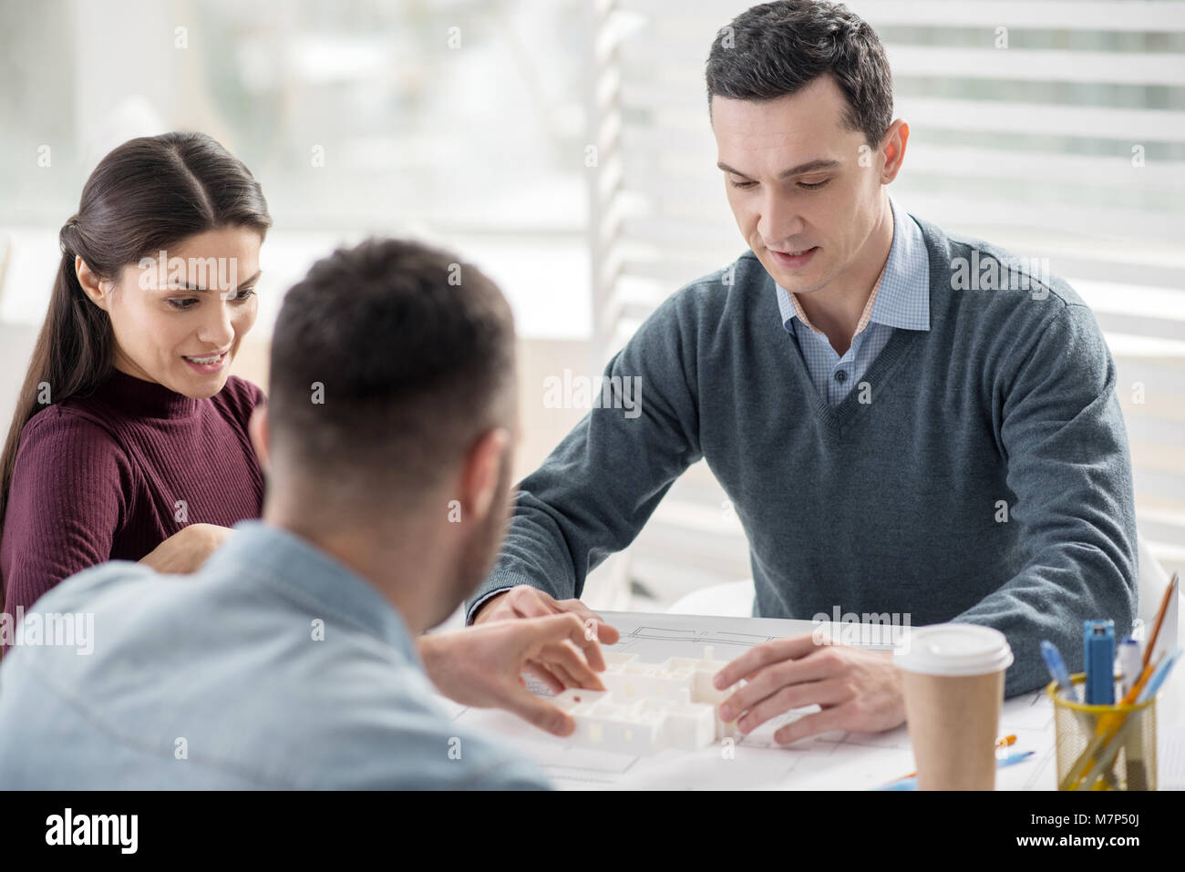 Serious man working with his colleagues Stock Photo - Alamy