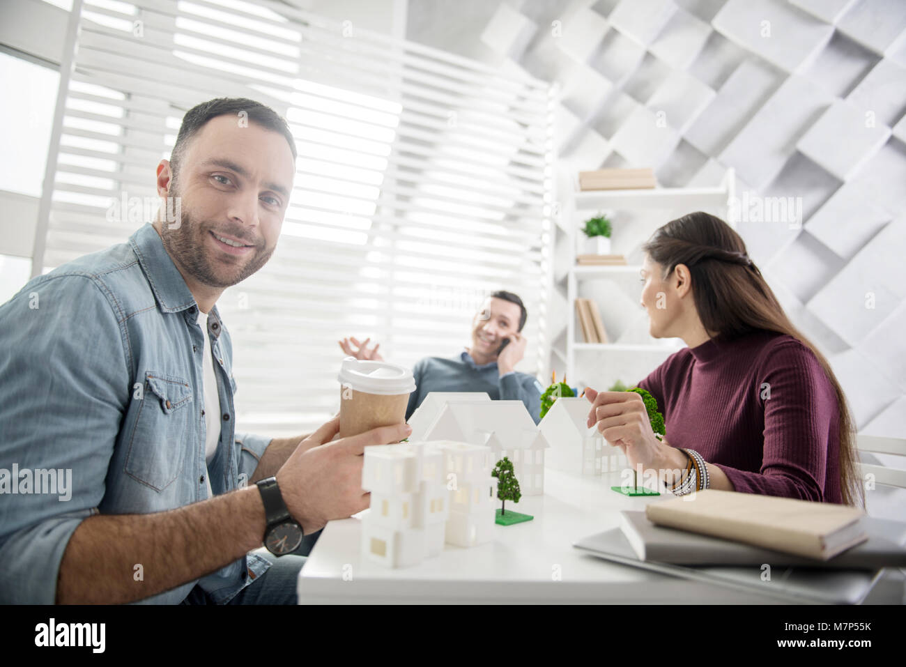 Happy man having coffee at work Stock Photo - Alamy