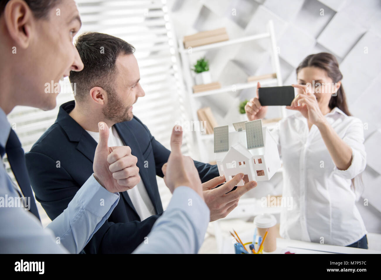 Joyful architects taking photos in the office Stock Photo - Alamy
