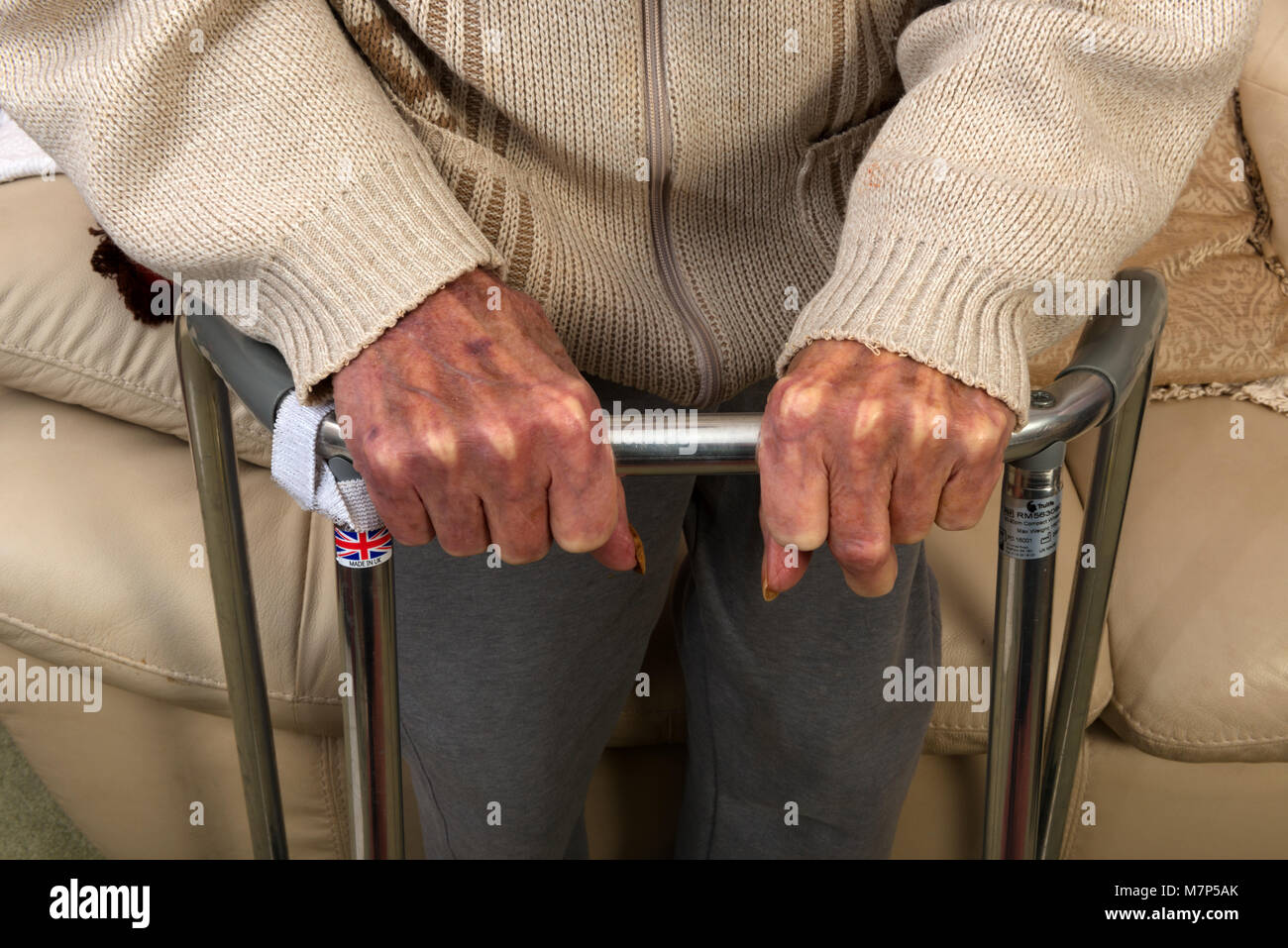 Elderly man using walking aid Stock Photo - Alamy