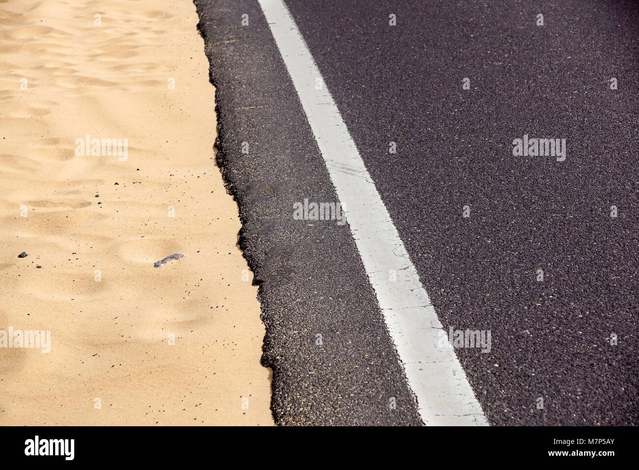 Asphalt way with white road marking in desert terrain of sand Stock ...
