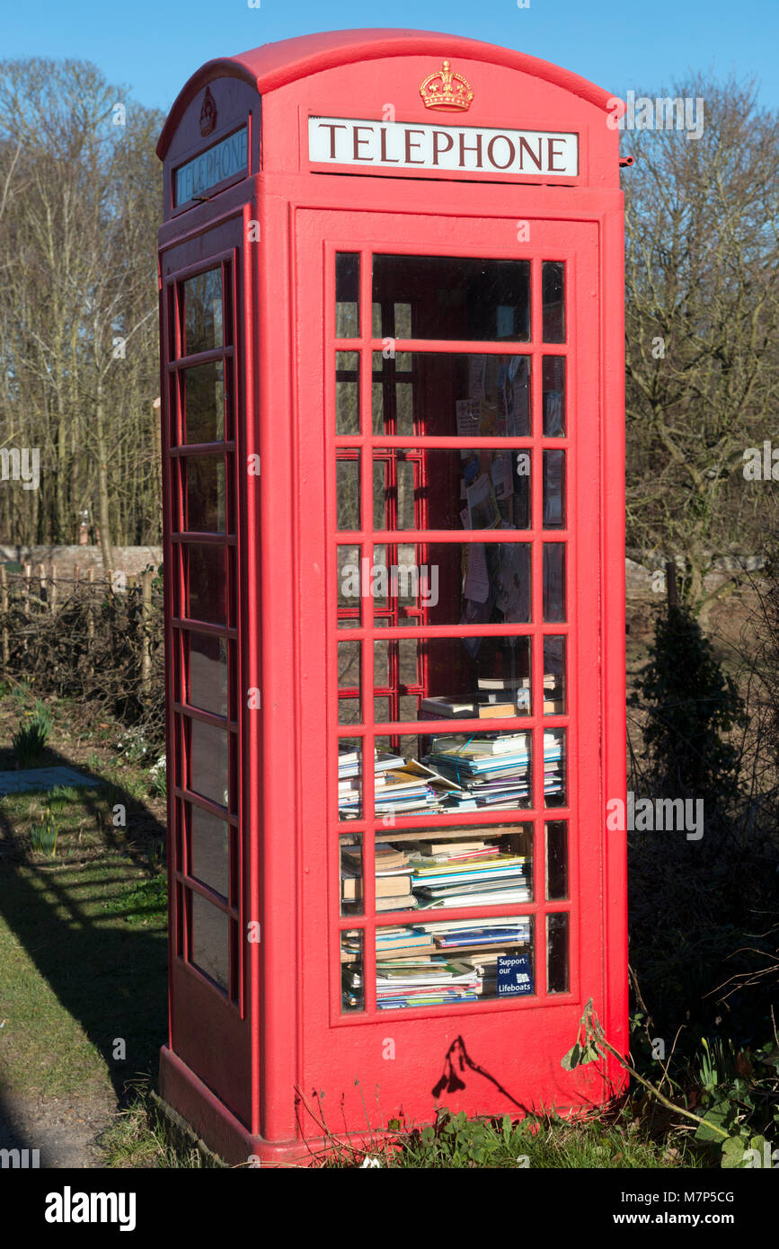 Disused red telephone box used as library Stock Photo - Alamy